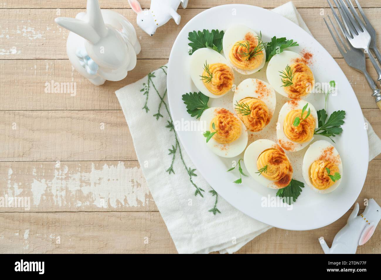 Easter stuffed eggs. Traditional Easter brunch or dinner with stuffed eggs with paprika, carrot ...