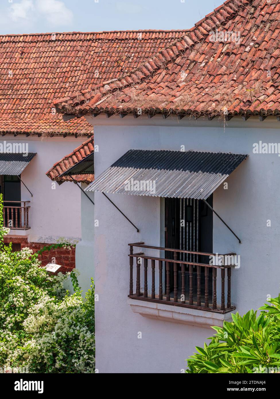 Indian house with Slanted roof with orange tiles Stock Photo - Alamy