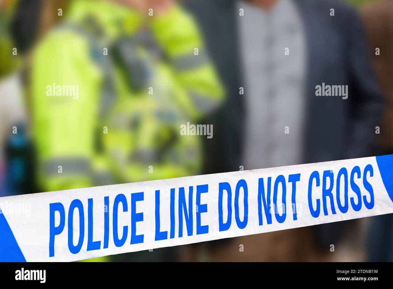 close up of police line do not cross tape at cordon around crime scene ...