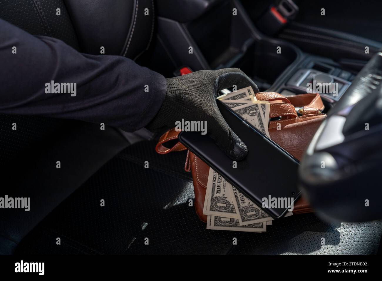 A thief is in the act of stealing valuables from a car Stock Photo - Alamy