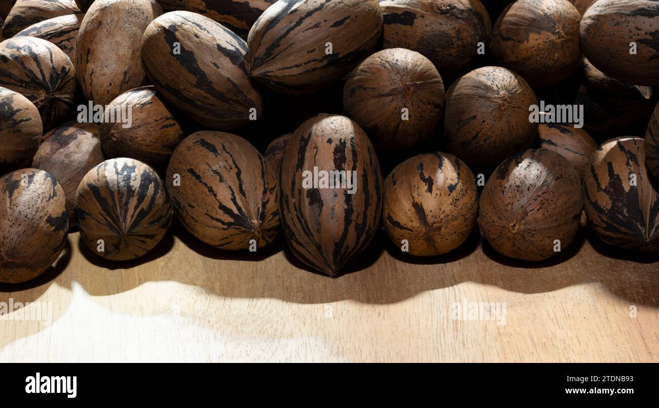 Bunch of pecans ready to be shelled on a wood surface Stock Photo - Alamy