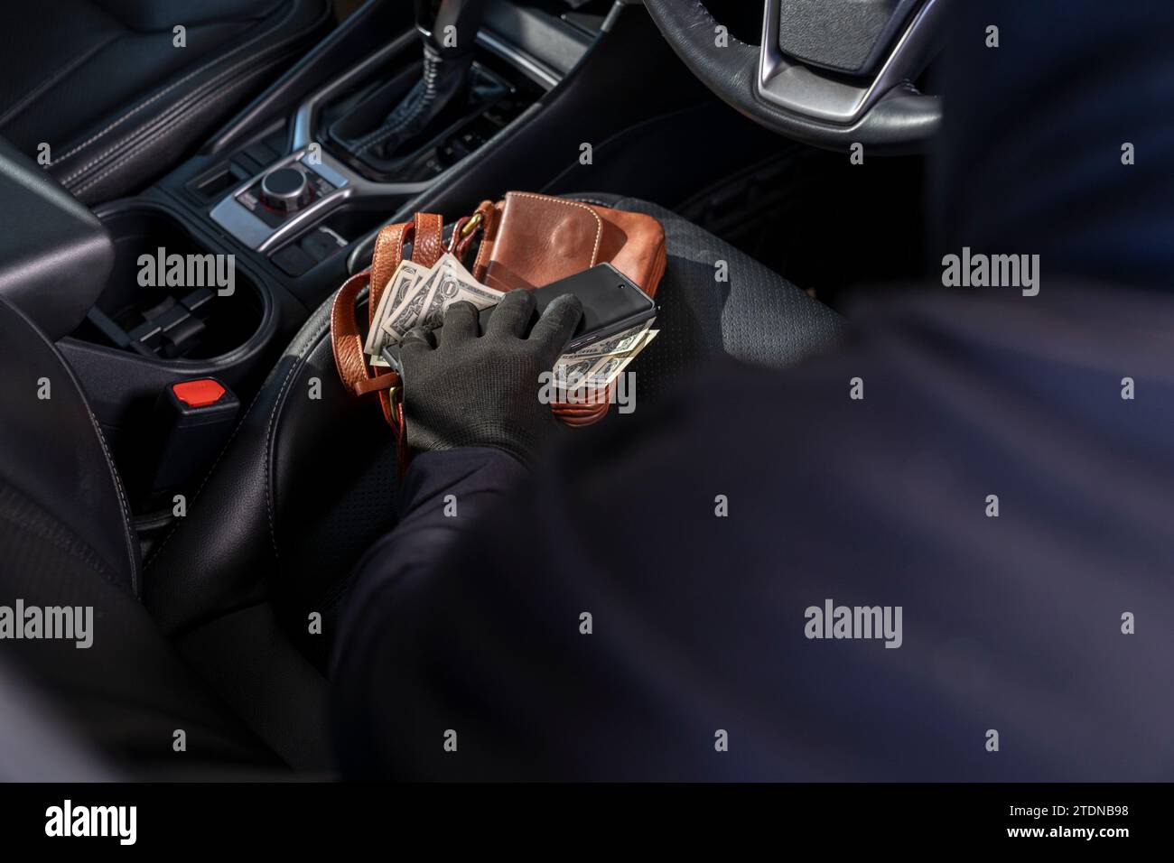 A thief is in the act of stealing valuables from a car Stock Photo - Alamy