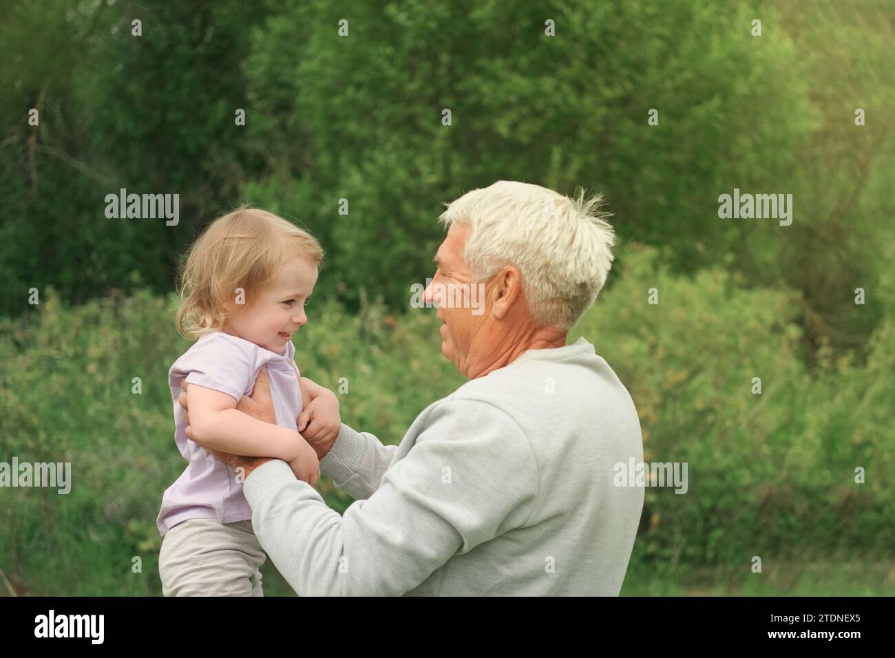 Grandfather and grandchild baby have fun during walk In Park. Happy ...