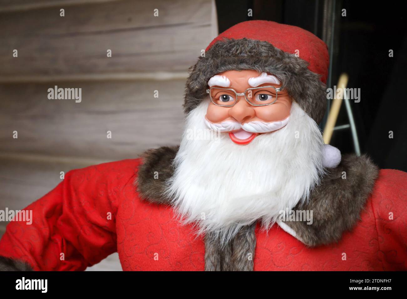 Santa claus big plastic figure with classic santa clothes and hat close ...
