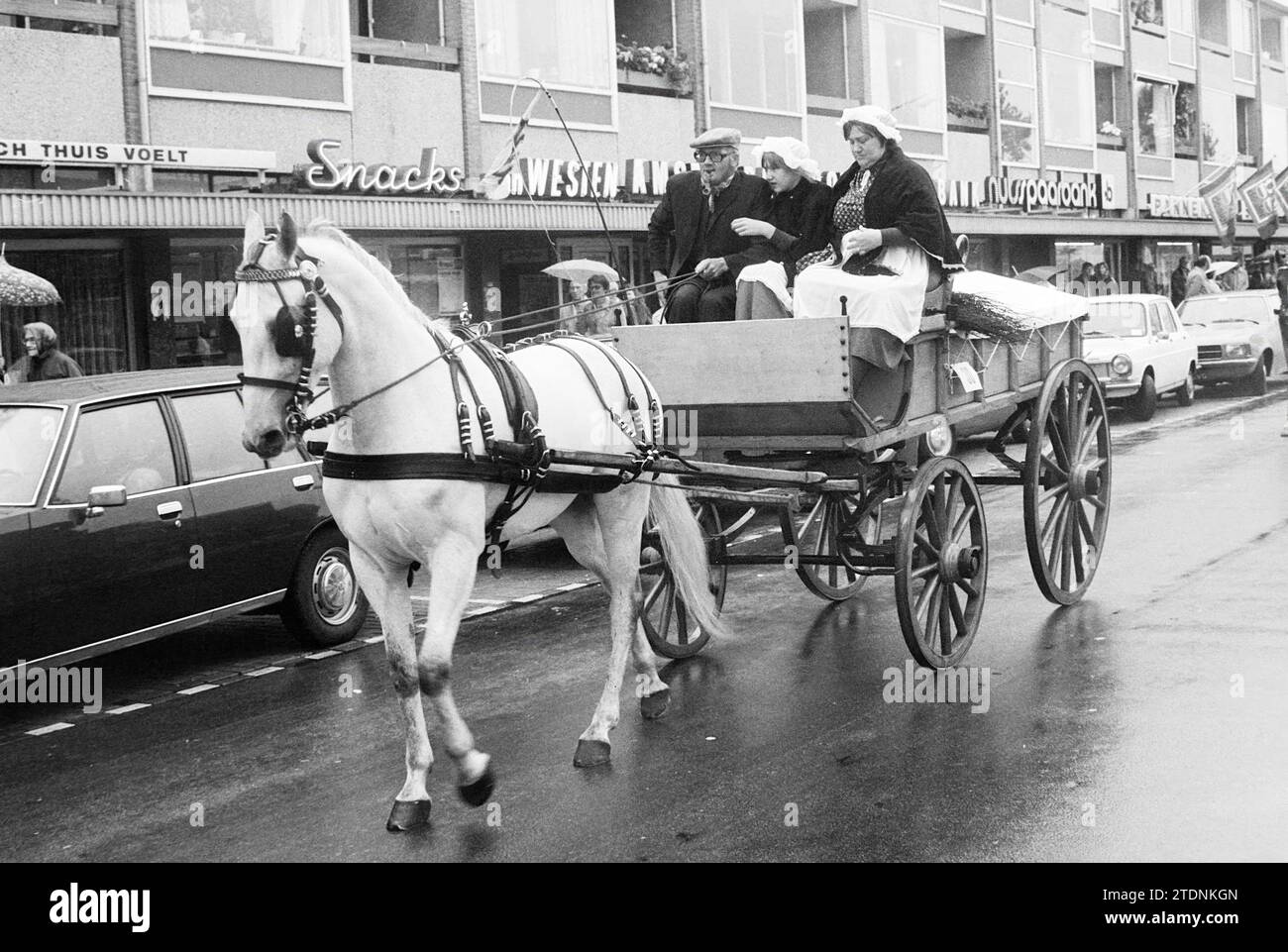 Procession of carriages with horses and people in traditional clothing ...