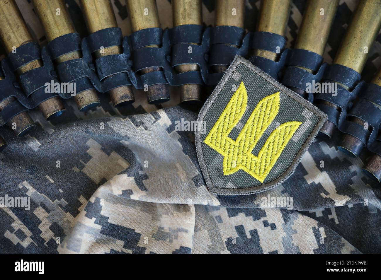 Ukrainian army symbol on machine gun belt lies on ukrainian pixeled ...