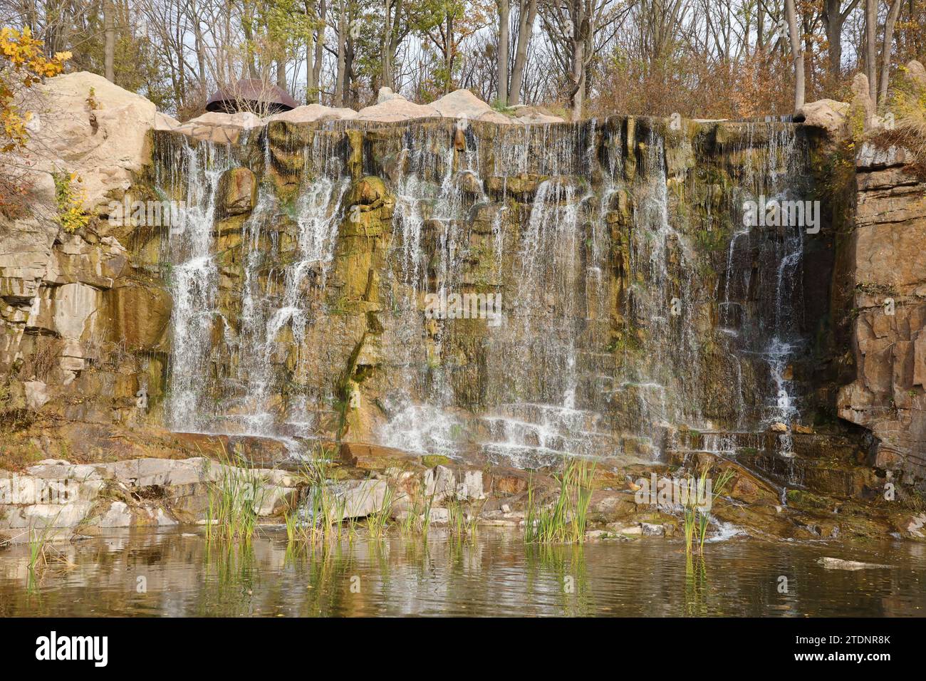 Beautiful waterfall between large rocks in the autumn forest ...