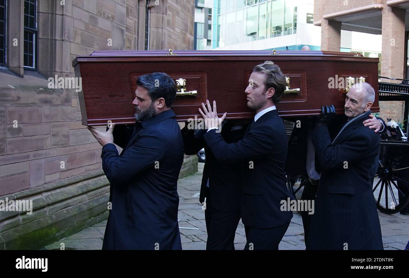 Pall bearers carry the coffin into the funeral for former Brookside ...