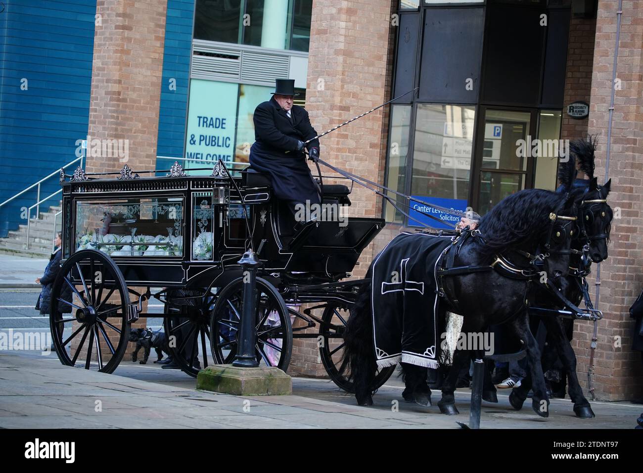 A horse and carriage leads the cortege arriving for the funeral of ...