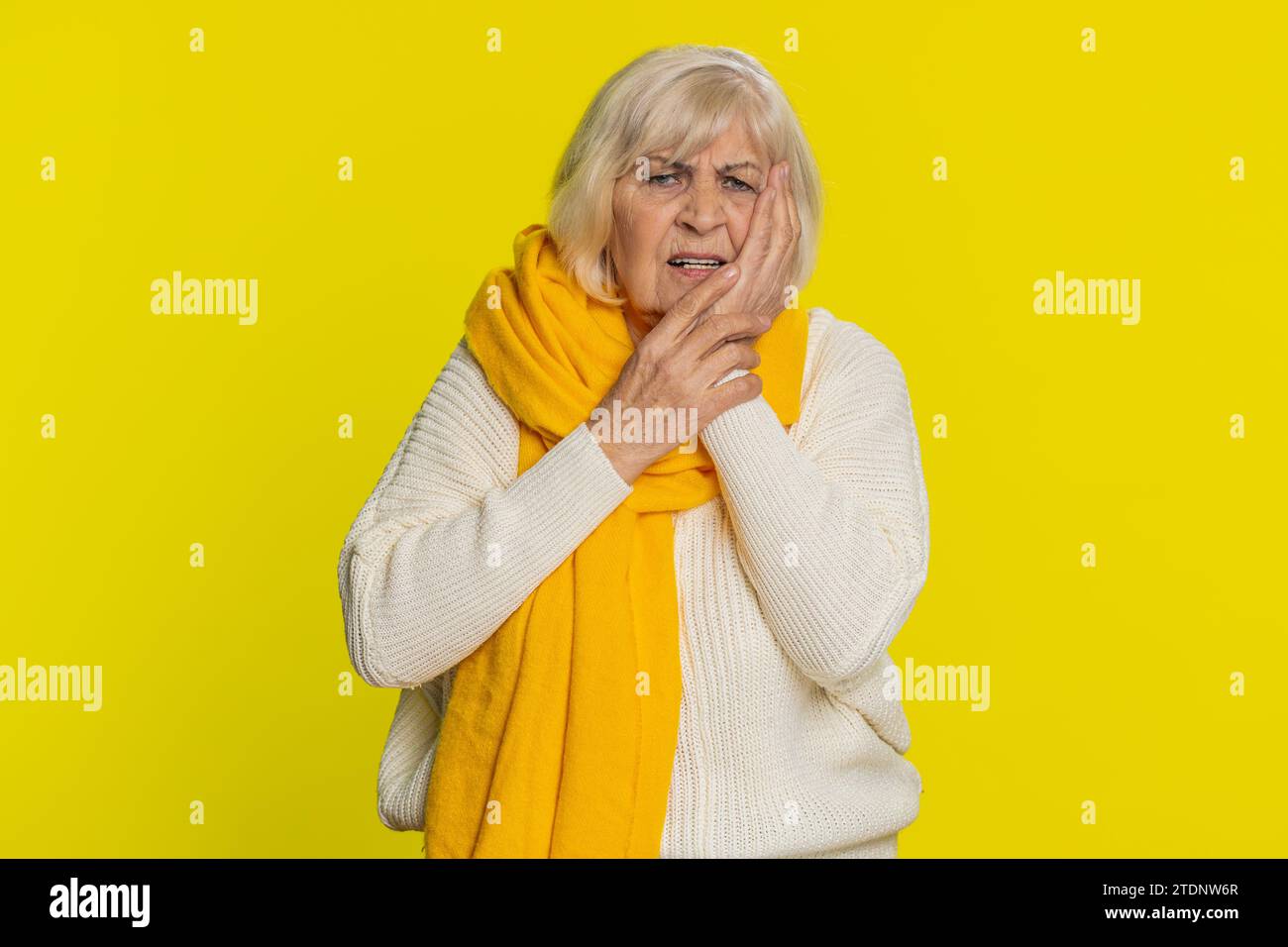 Dental problems. Senior old woman touching cheek, closing eyes with ...