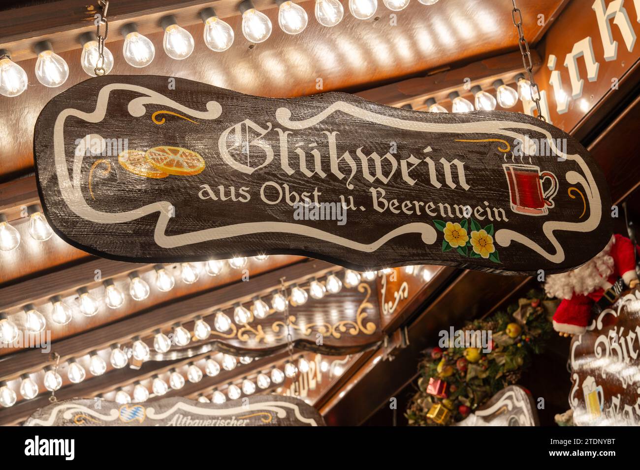 A wooden sign advertises the seasonal drink, Glühwein, or mulled wine ...