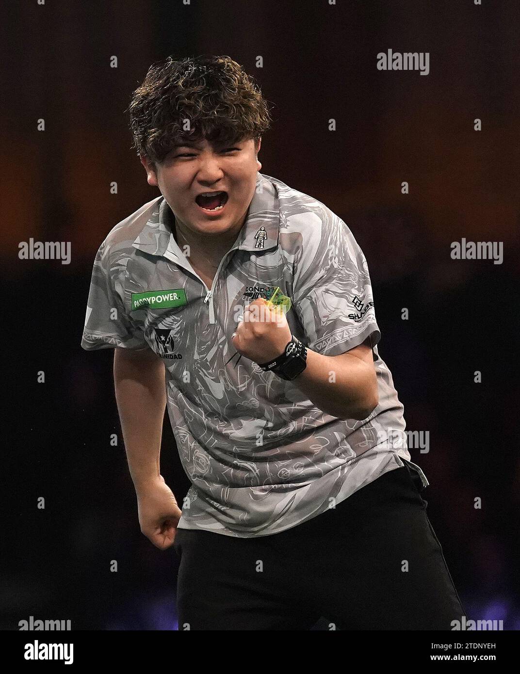 Tomoya Goto celebrates his win against Ian White (not pictured) on day ...