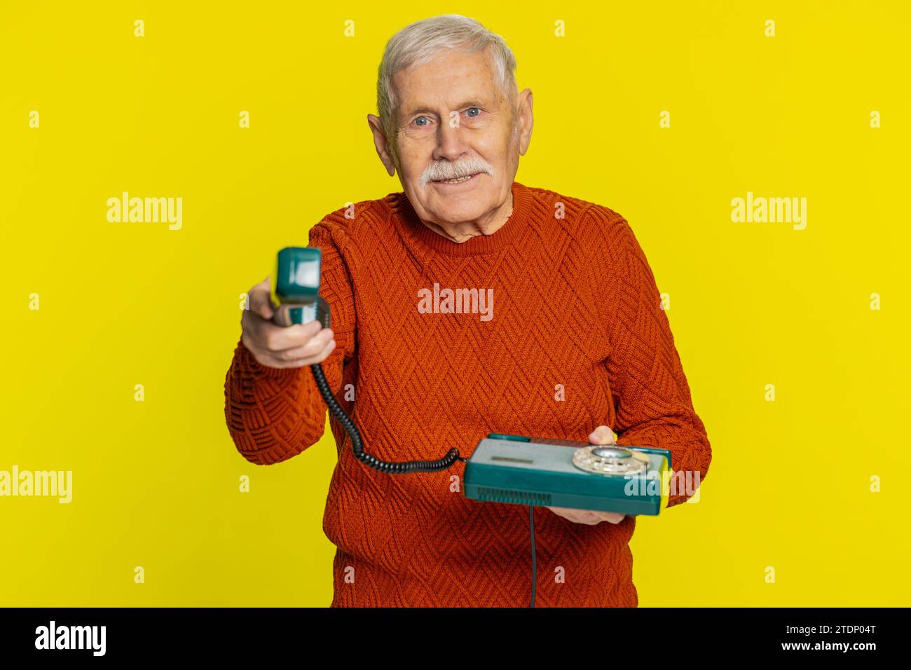 Hey you, call me back. Senior old man talking on wired landline vintage ...