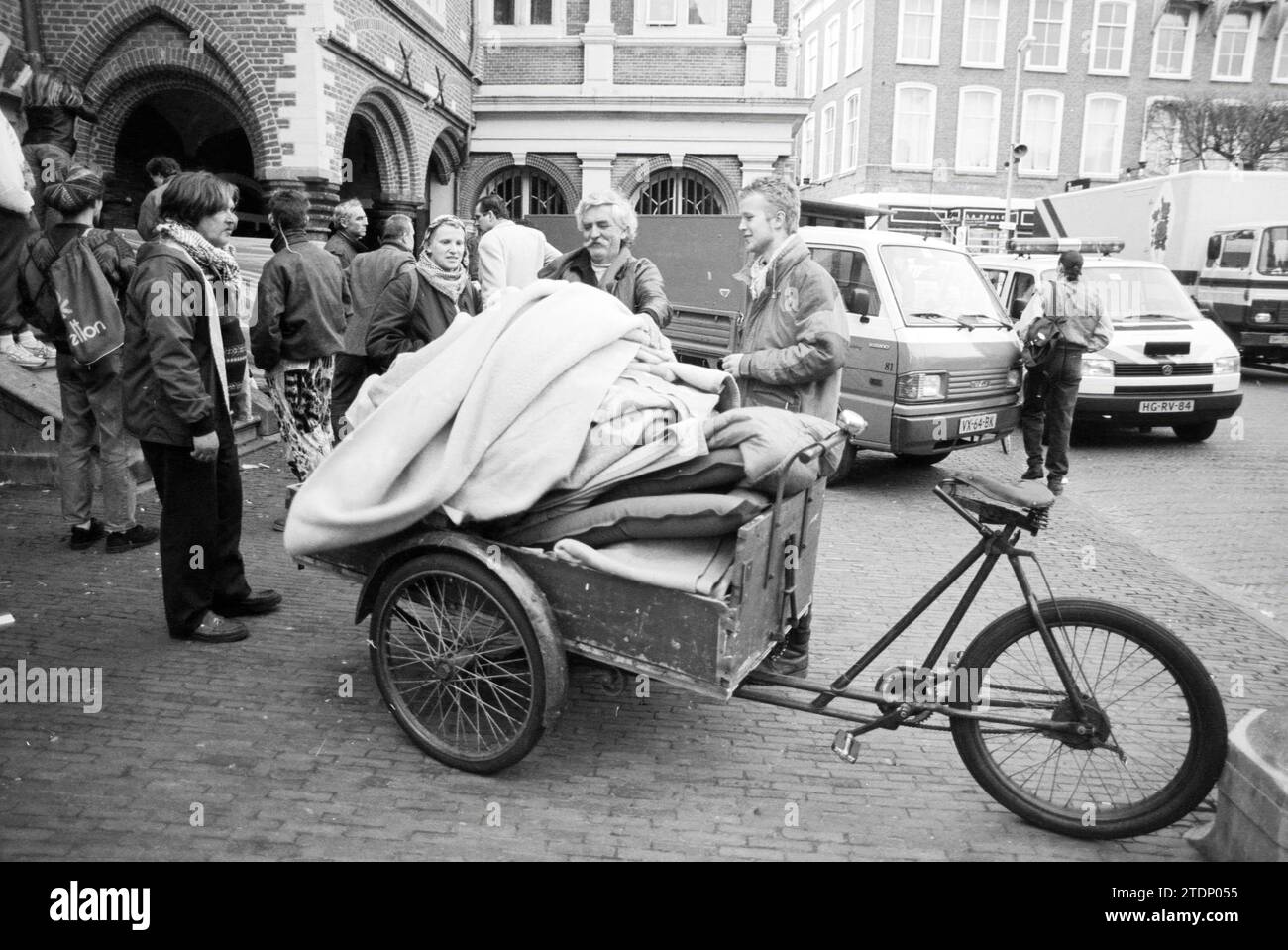 Homeless people sleep at the bottom of the stairs of the city hall ...