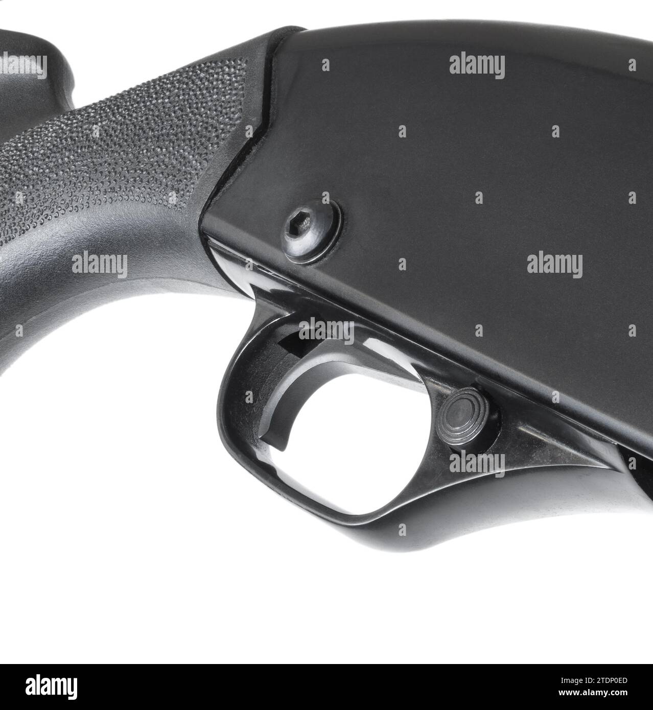Safety in front of a black shotgun's trigger that is engaged to keep ...