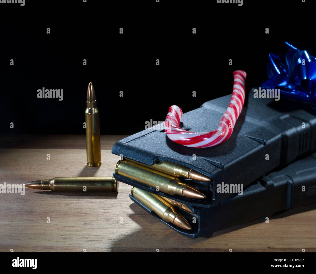 Blue bow and candy cane on two fully loaded polymer AR-15 magazines on ...