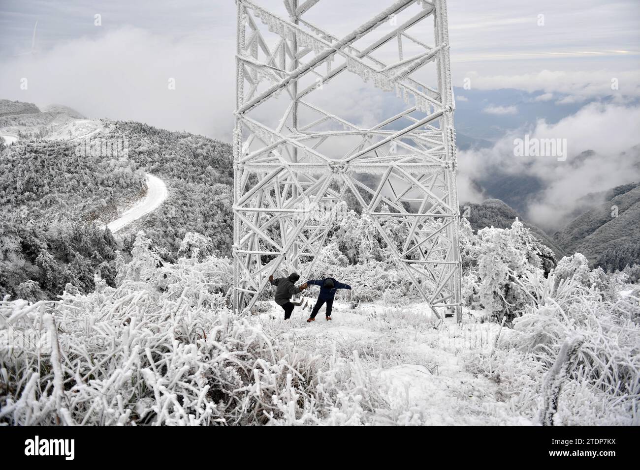 Huaihua, China. 19 December, 2023. Power supply technicians Yin Bin (R ...