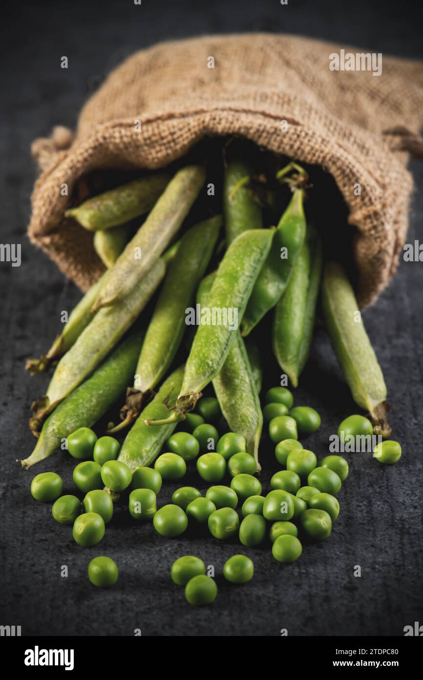 green peeled peas in a bowl on black background Stock Photo - Alamy