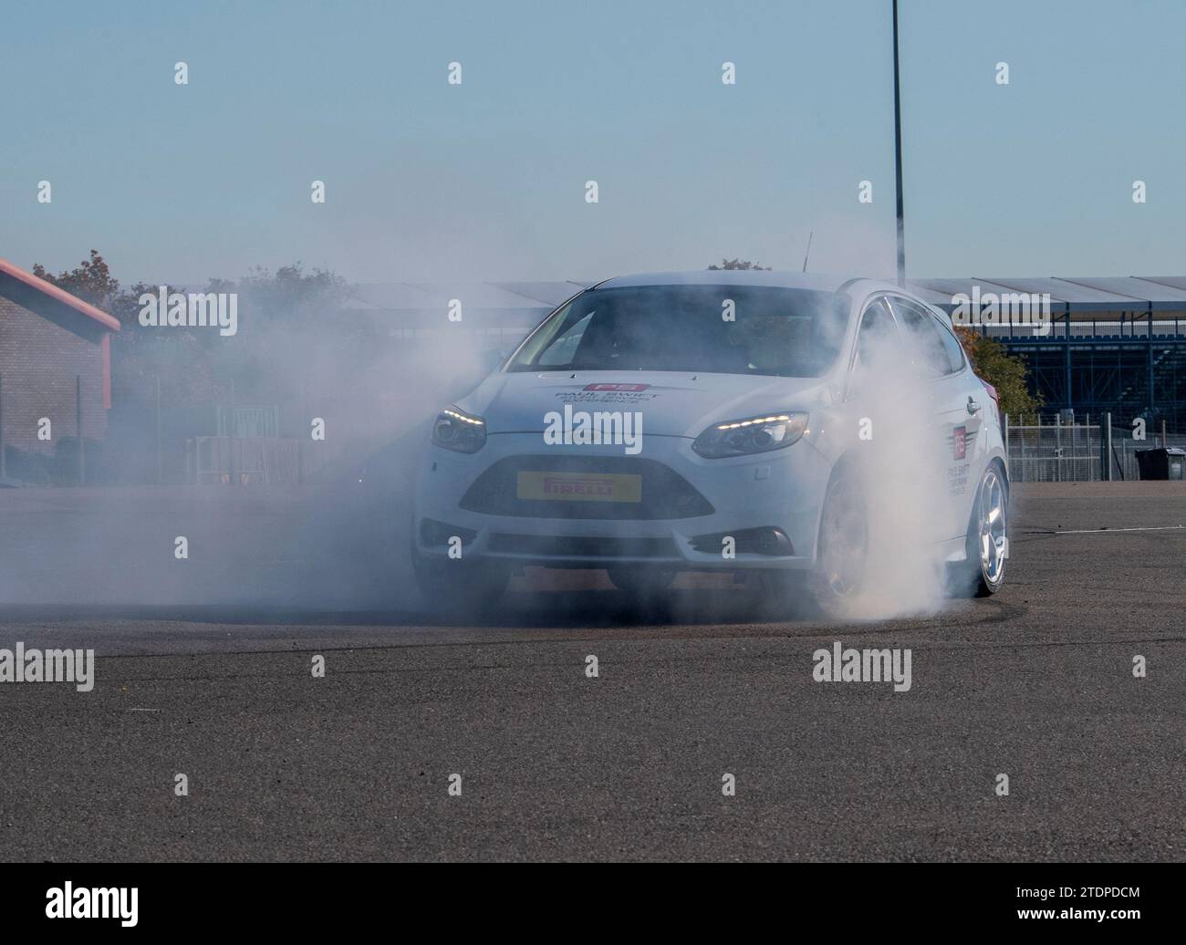 Stunt driver Paul Swift driving his Ford Focus on 2 wheels and Mustang ...