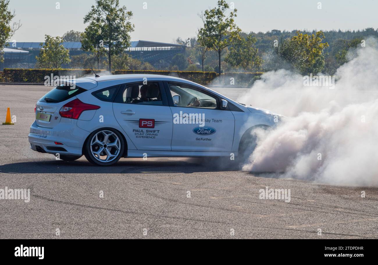 Stunt driver Paul Swift driving his Ford Focus on 2 wheels and Mustang ...