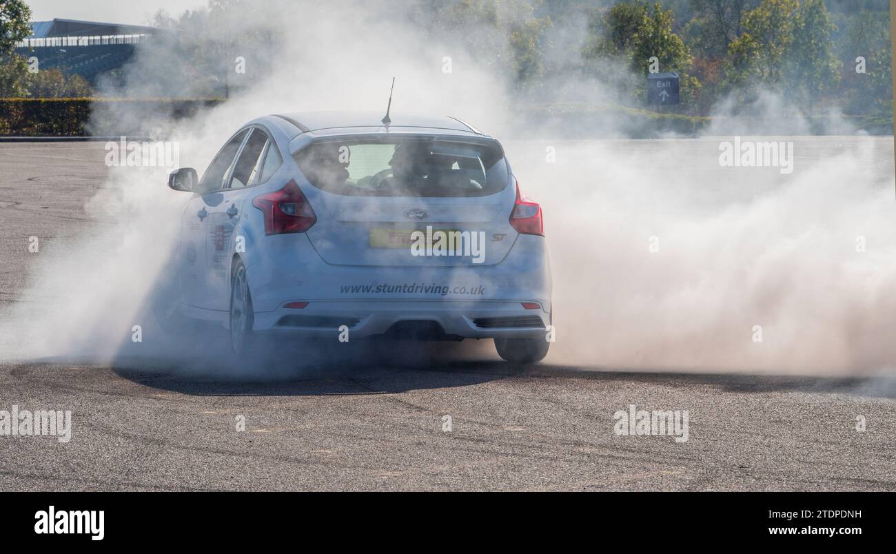 Stunt driver Paul Swift driving his Ford Focus on 2 wheels and Mustang ...