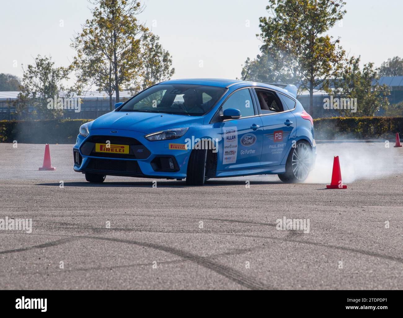 Stunt driver Paul Swift driving his Ford Focus on 2 wheels and Mustang ...