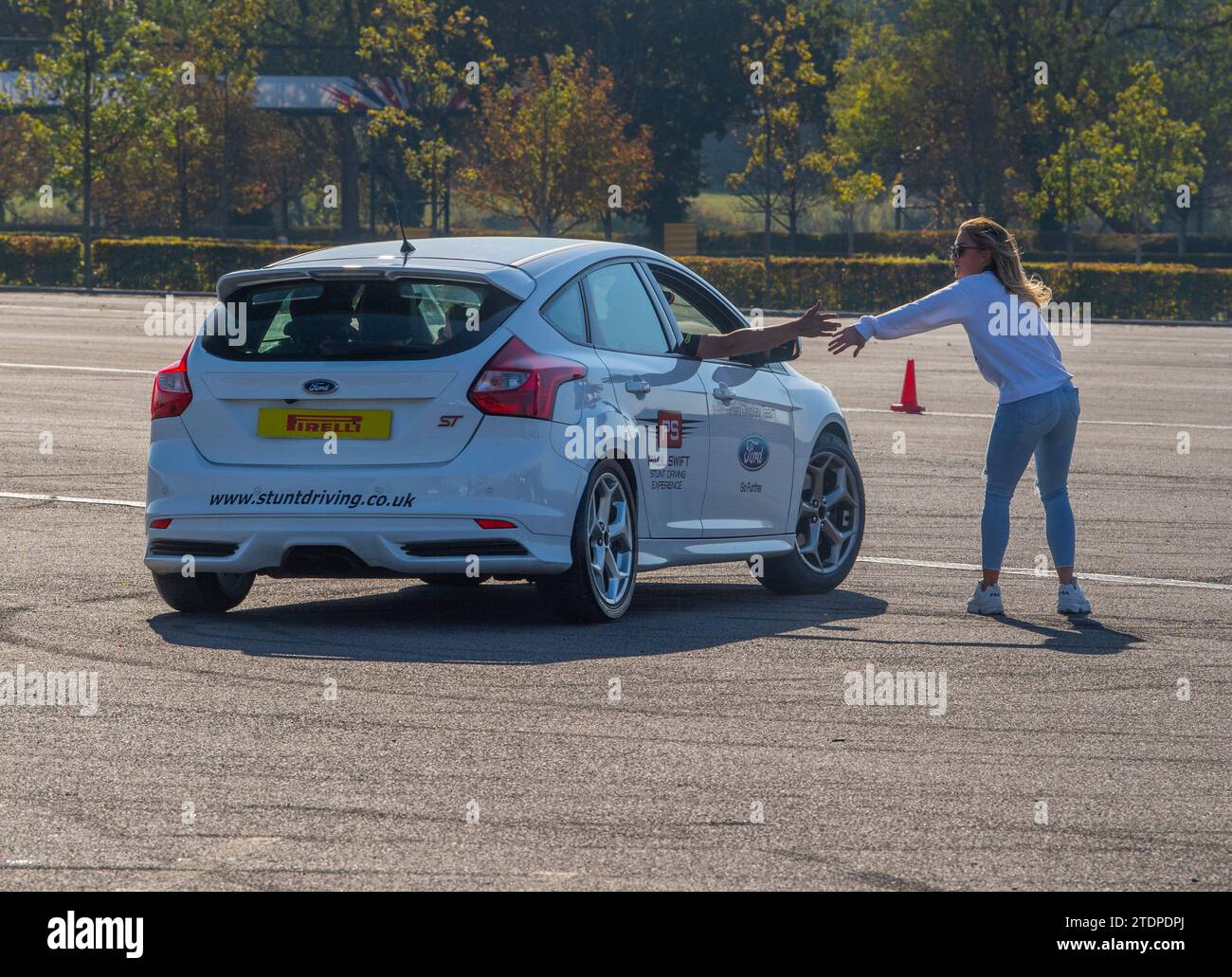 Stunt driver Paul Swift driving his Ford Focus on 2 wheels and Mustang ...