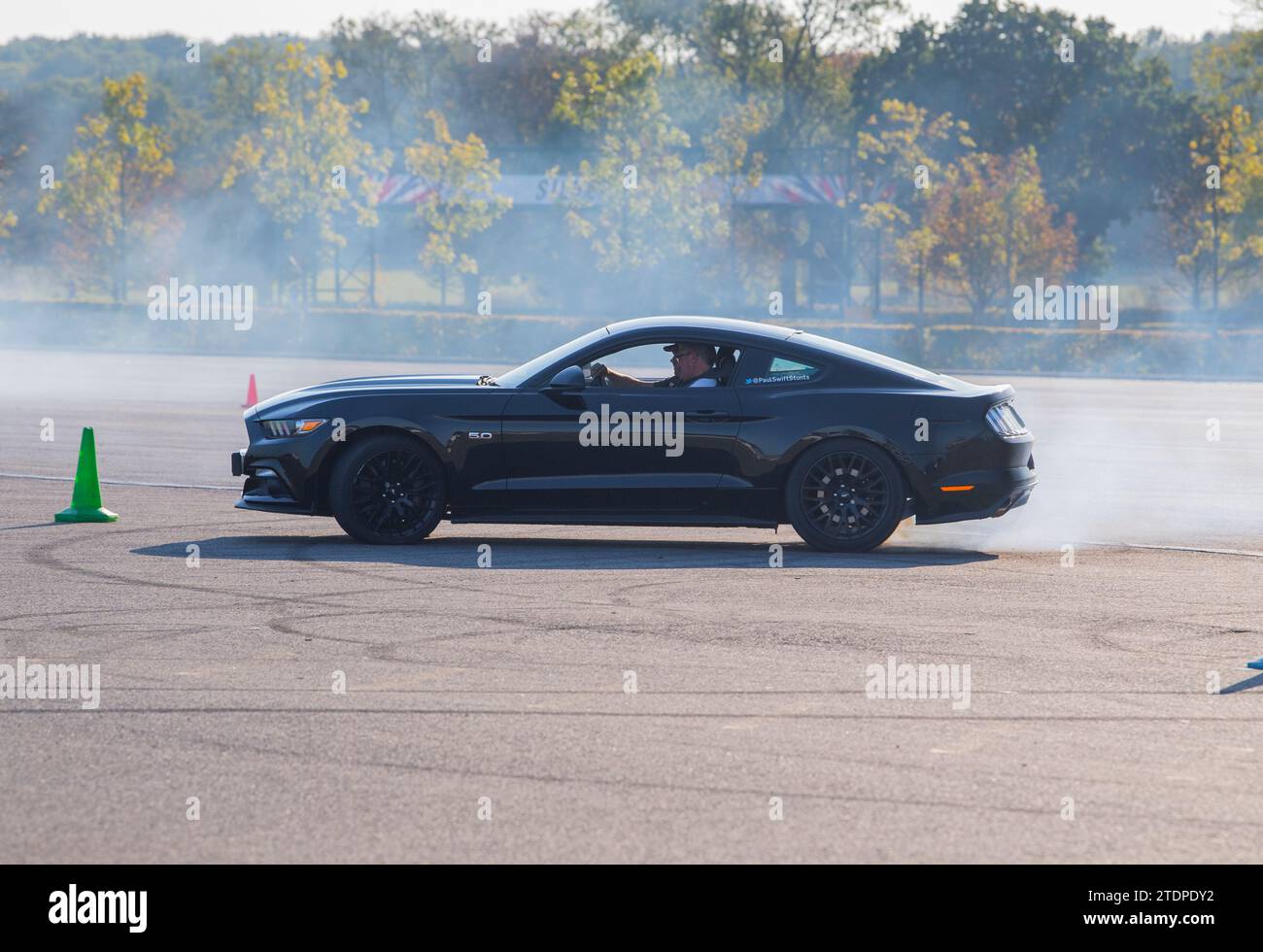 Stunt driver Paul Swift driving his Ford Focus on 2 wheels and Mustang ...