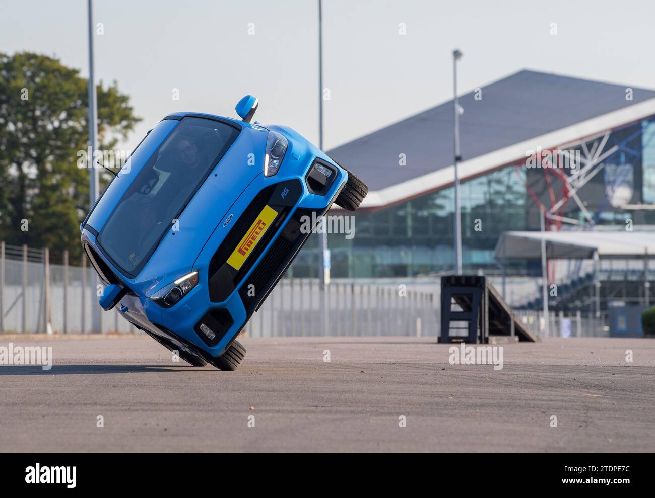 Stunt driver Paul Swift driving his Ford Focus on 2 wheels and Mustang ...