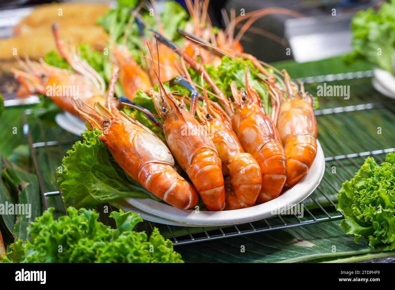 King prawns with lettuce on a street food stand Stock Photo - Alamy