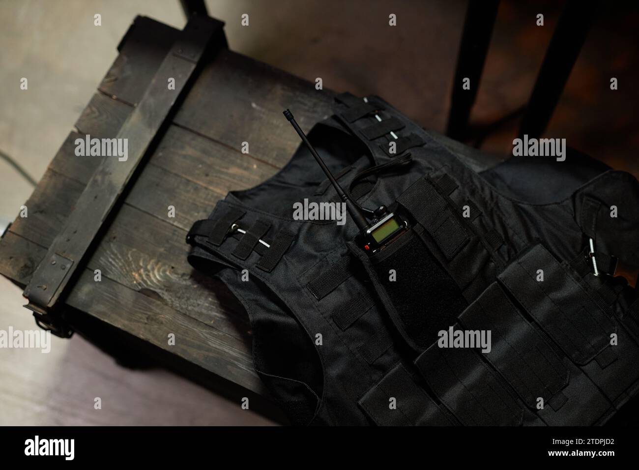 Above angle of black protective bulletproof body armor with walkie ...