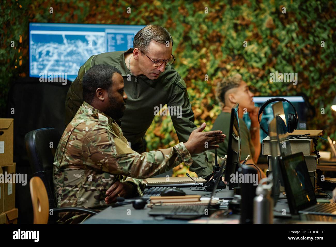 Young African American military officer in camouflage uniform pointing ...