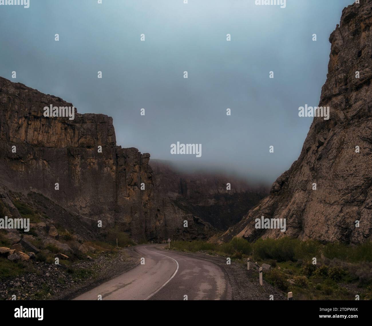 winding road in a gloomy foggy rocky mountains, Pass in the Karatau ...