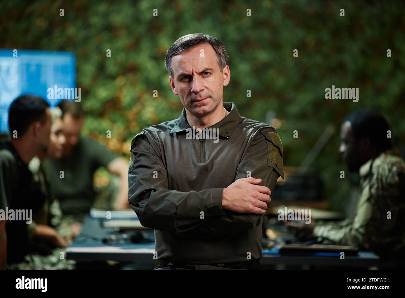 Confident mature male security officer crossing his arms by chest and ...