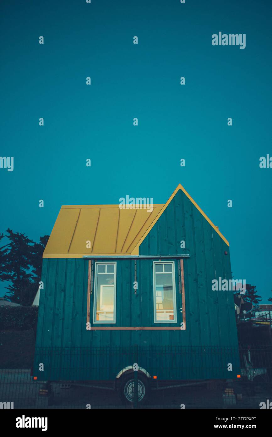 Modern blue tiny house on wheels at the twilight. Copy space for text ...
