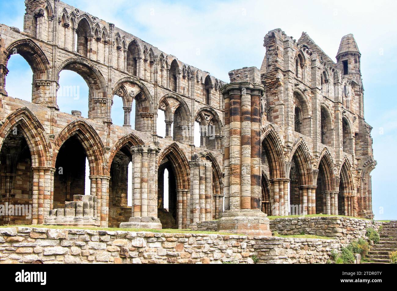 A view of Whitby Abbey in Yorkshire with its ruined windows, columns ...