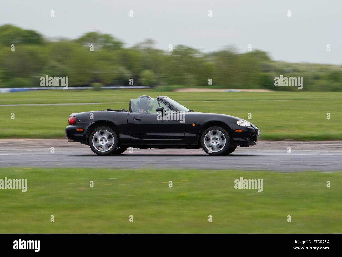Mazda MX5 driving fast on track during a race track day event Stock ...
