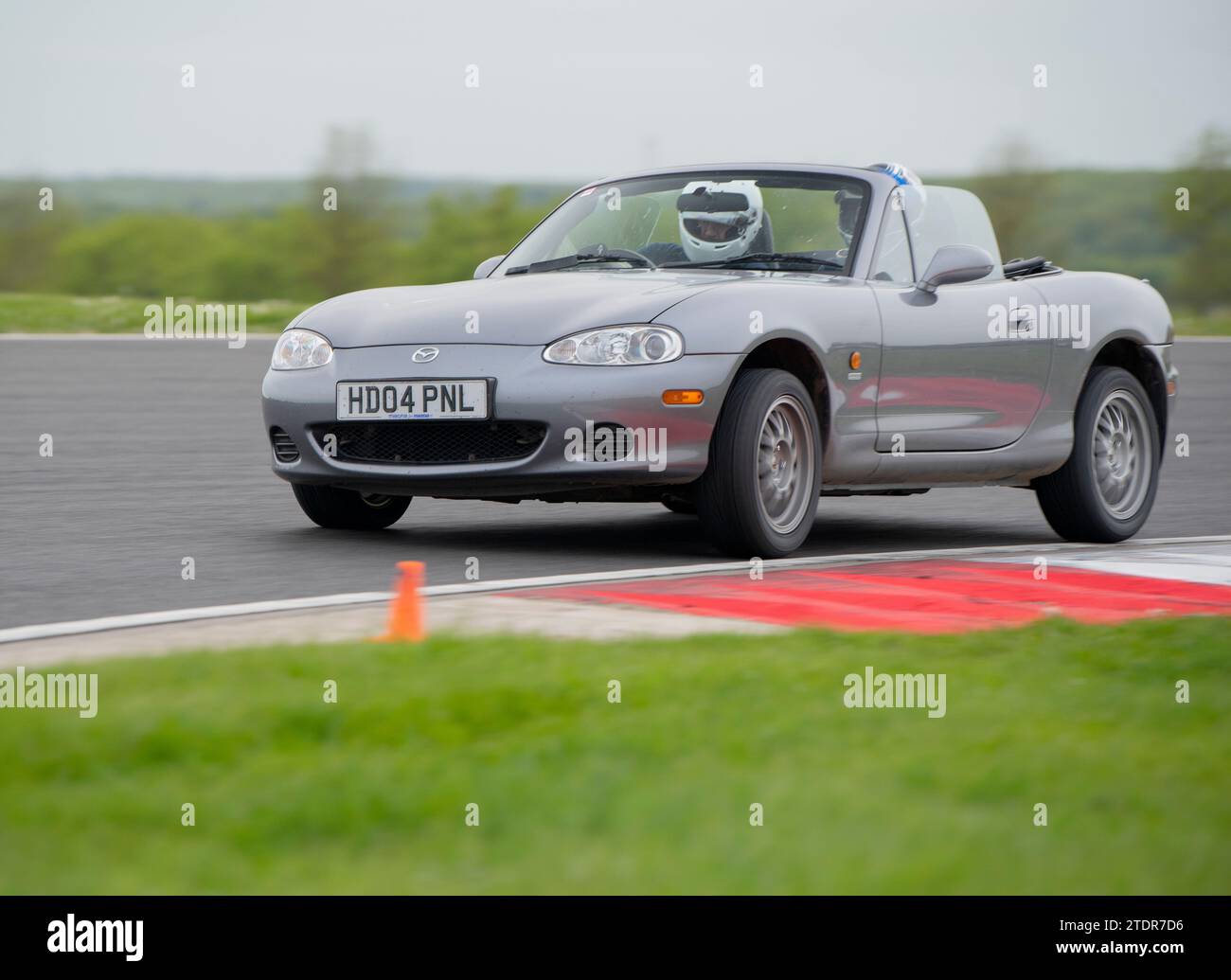 Mazda MX5 driving fast on track during a race track day event Stock ...