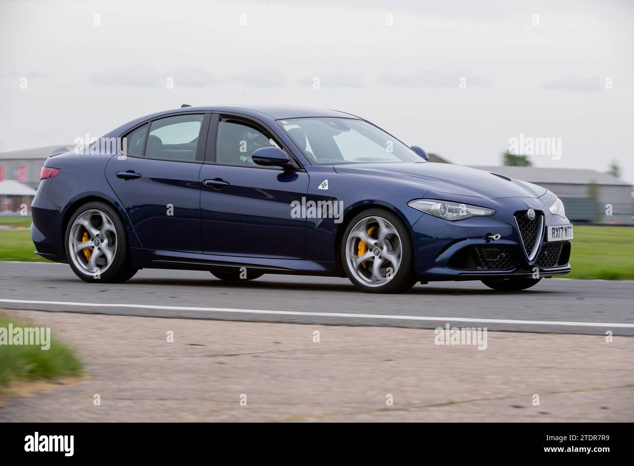 Alfa Romeo Giulia Quadrofolglio driving fast on track during a race ...