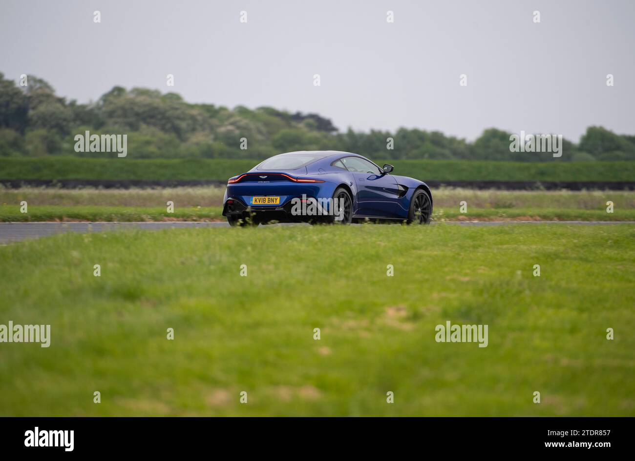 Aston Martin Vantage driving fast on track during a race track day ...
