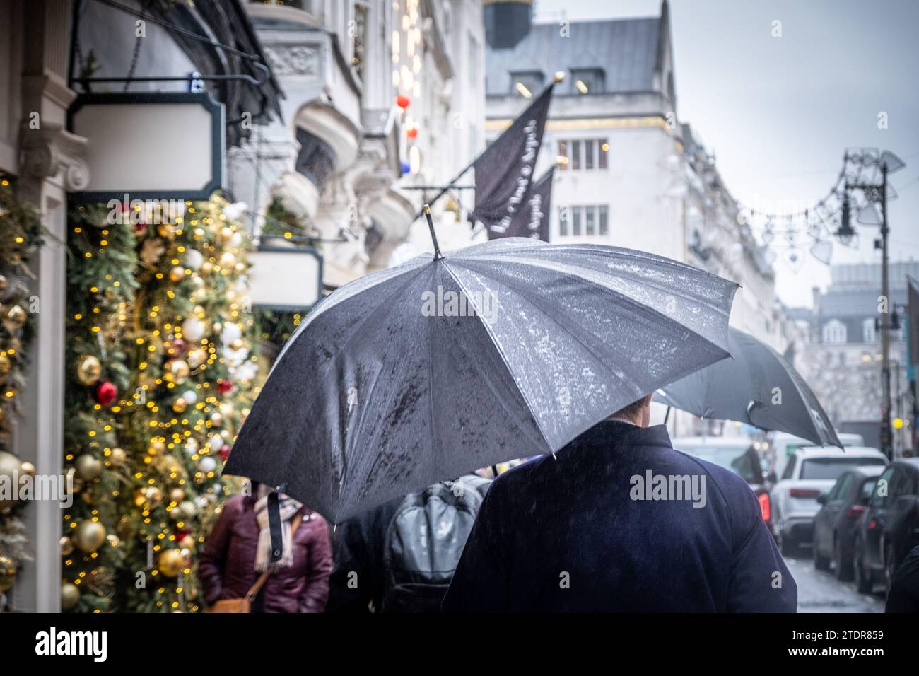 Rainy London street scene with umbrella and retail shops Stock Photo ...