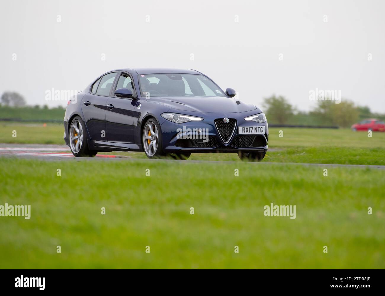 driving fast on track during a race track day event Stock Photo - Alamy
