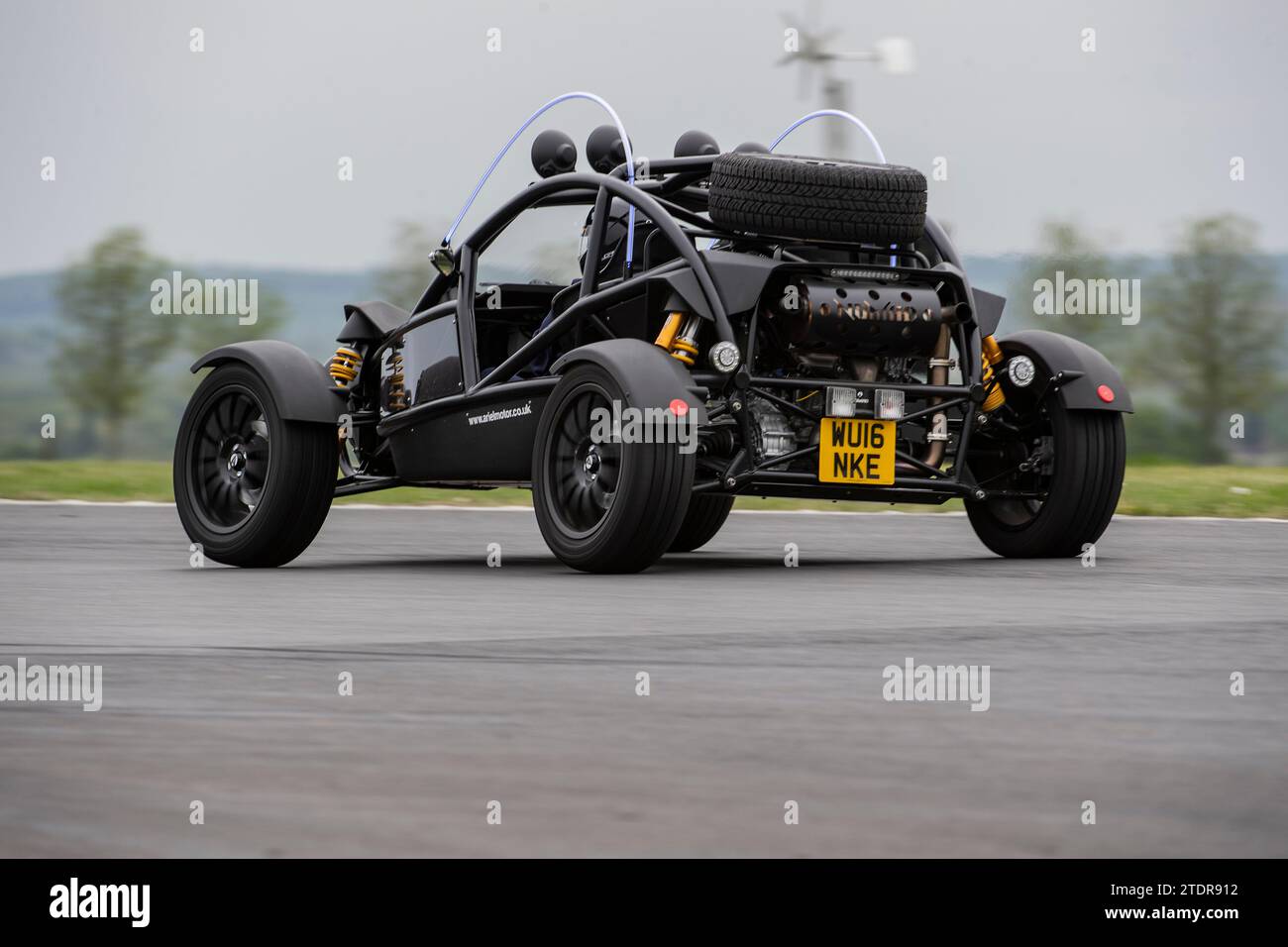 Car driving fast on track during a race track day event Stock Photo - Alamy