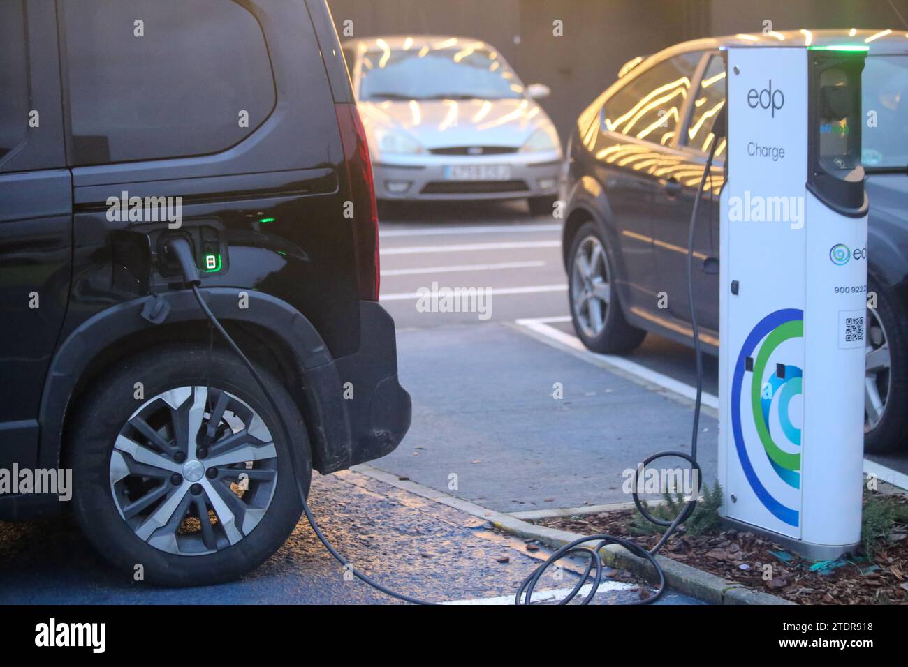 Paredes, Spain, December 19, 2023: A vehicle charging battery during ANFAC reports that more ...