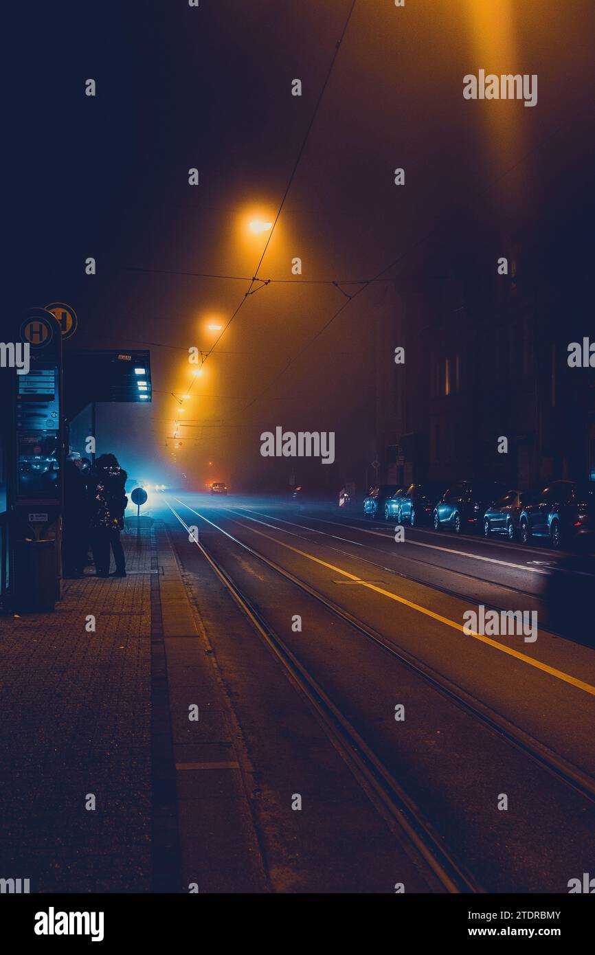 On the foggy street at night with warm lamp light Stock Photo - Alamy