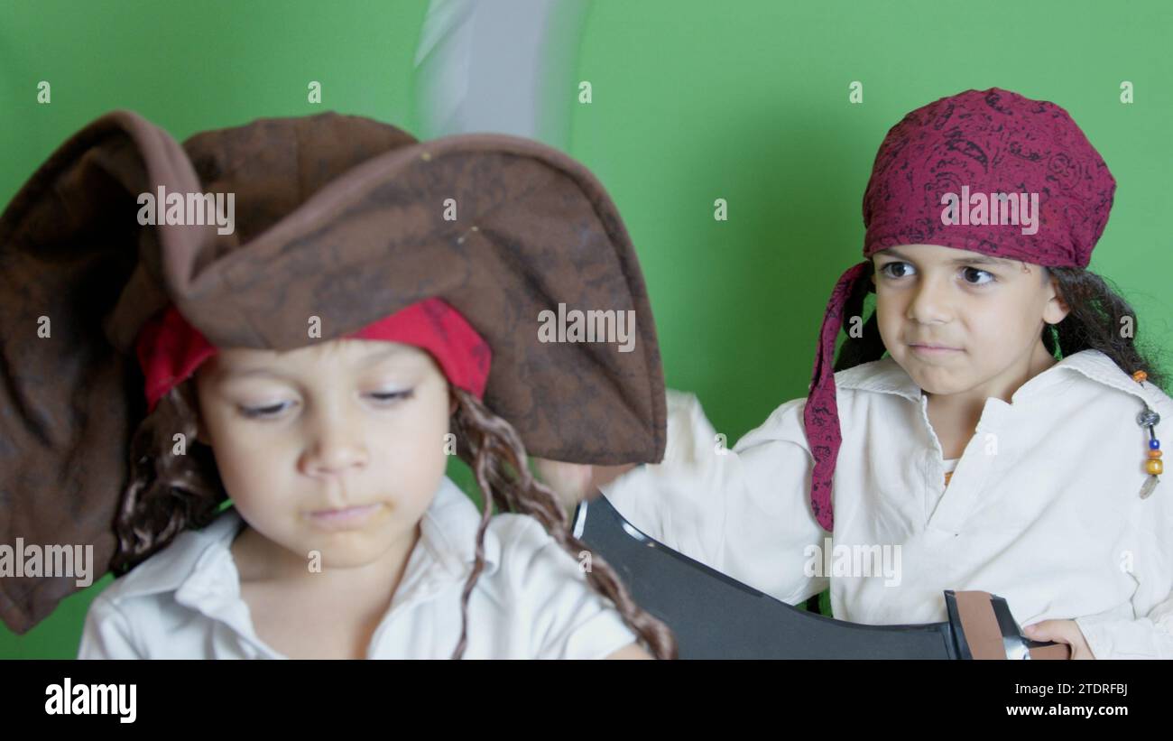 Pirates fight with cutlasses. Cute brothers dressed as pirates playing ...