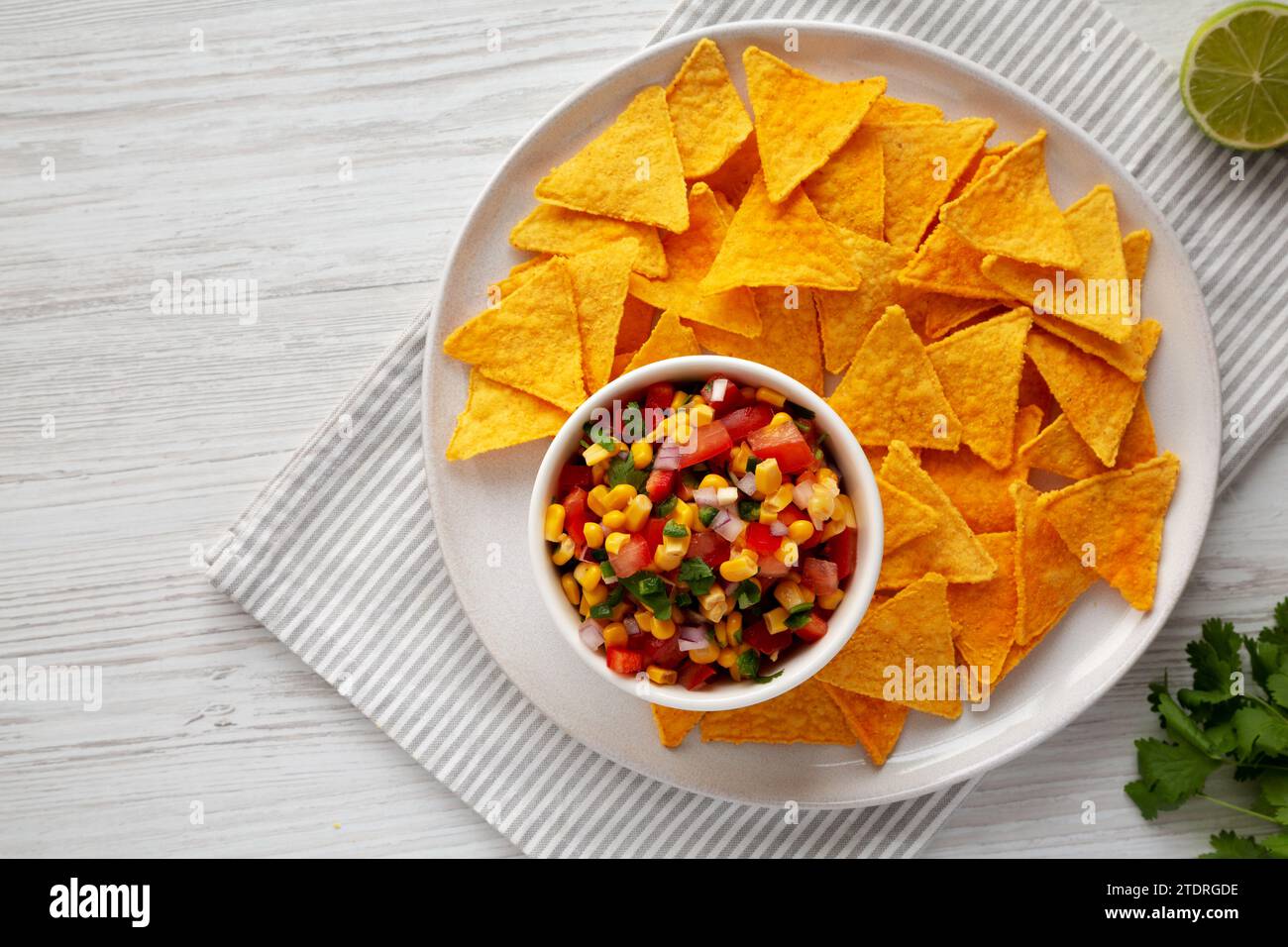Homemade Corn Salsa with Tortilla Chips on a Plate, top view. Overhead ...