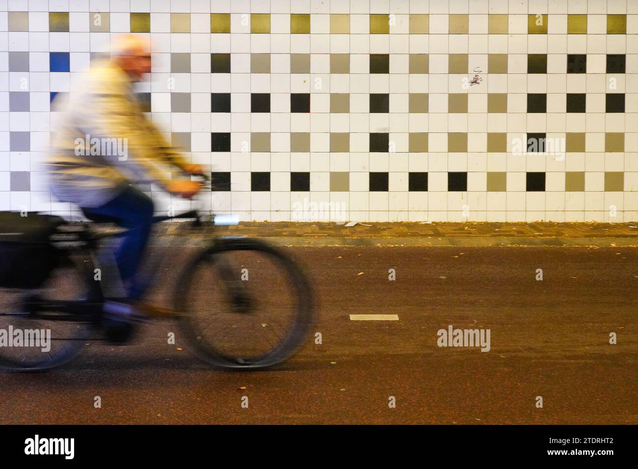 A senior citizen cyclist crosses an underpass on a cycle path Stock ...