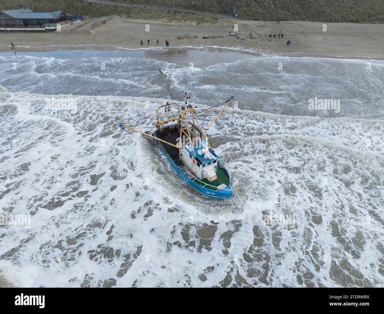 Aerial drone view of fishing ship stranded and stuck in shallow water ...