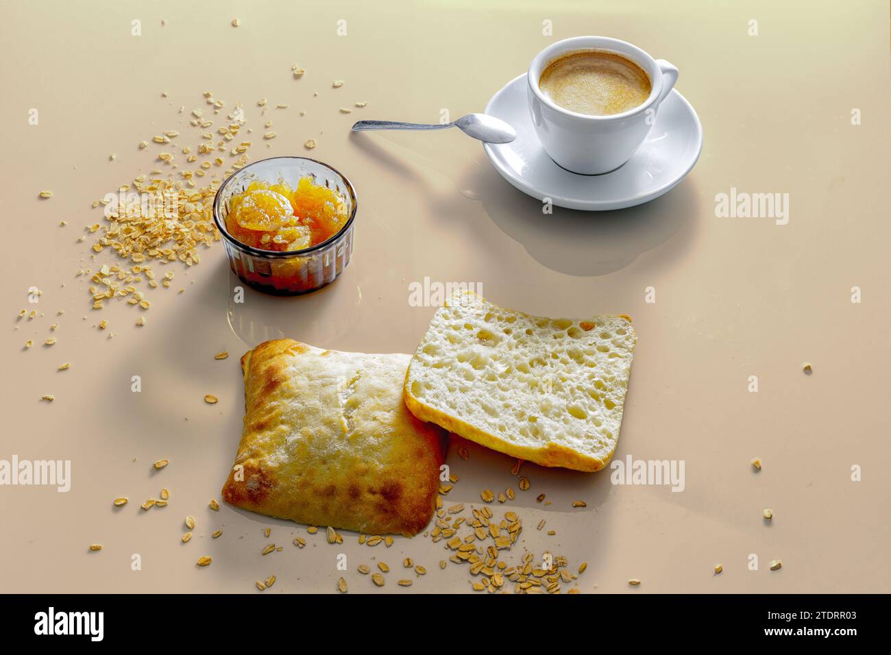 An ascetic breakfast. Jam, coffee and toast. Beige background, oatmeal ...